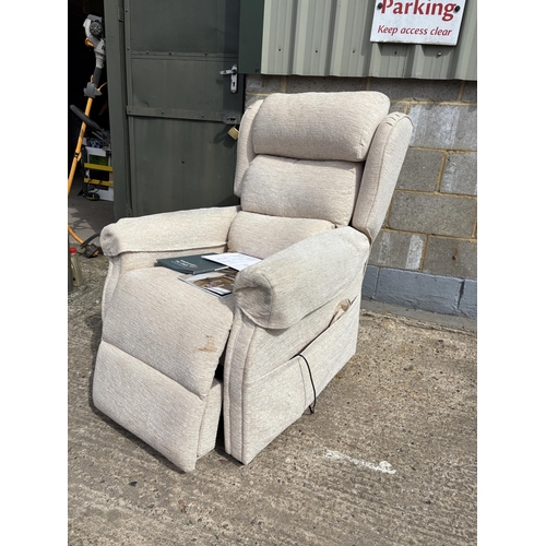 A beige upholstered rise and recline chair by OAK TREE MOBILITY