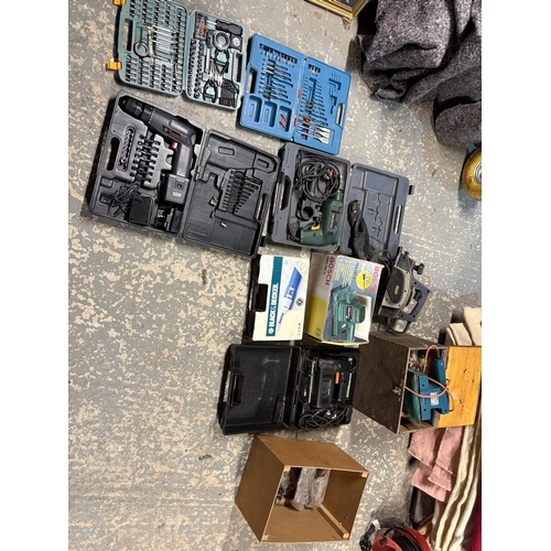 A collection of assorted power tools including Bosch drill, sanders ...