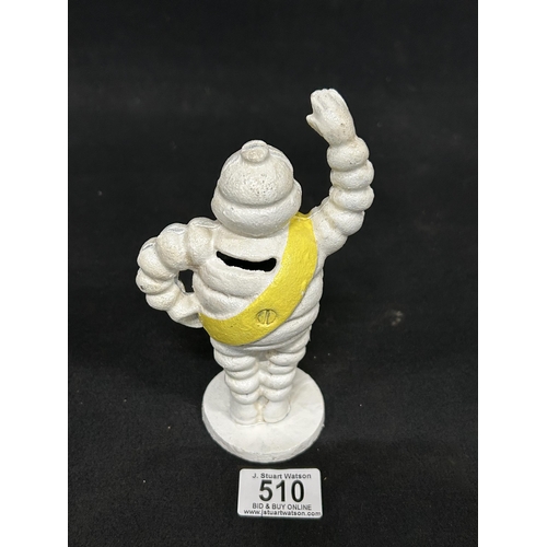 Cast iron waving Michelin man money box, height 17cms