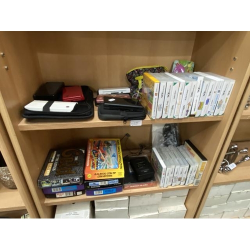 2 shelves of 7 Nintendo DS consoles, games, Sony walkman, 9 Atari games ...
