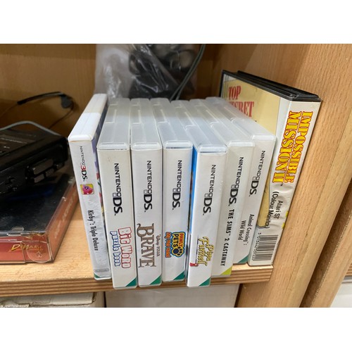 2 shelves of 7 Nintendo DS consoles, games, Sony walkman, 9 Atari games ...