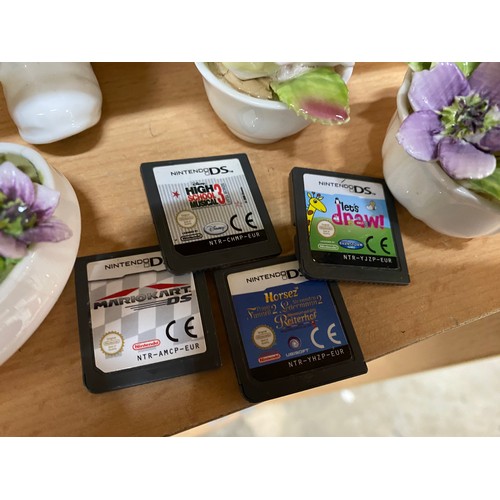 2 shelves of 7 Nintendo DS consoles, games, Sony walkman, 9 Atari games ...