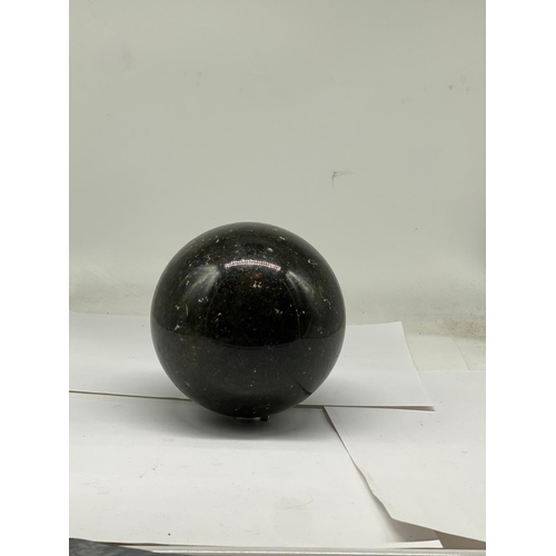 A natural granite sphere. The polished spherical object presents a very ...