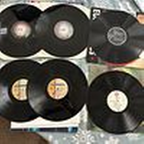 This lot comprises four vintage musical vinyl record albums and singles ...