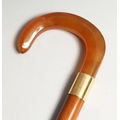 A GOOD AMBER WALKING STICK with 18ct gold band