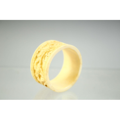 A SET OF FOUR CHINESE CARVED IVORY NAPKIN RINGS, each carved with a ...