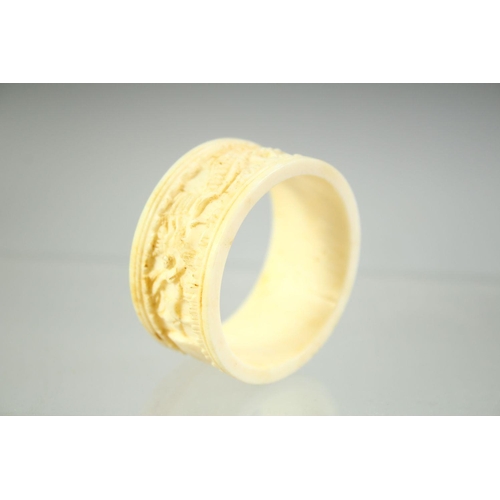 A SET OF FOUR CHINESE CARVED IVORY NAPKIN RINGS, each carved with a ...