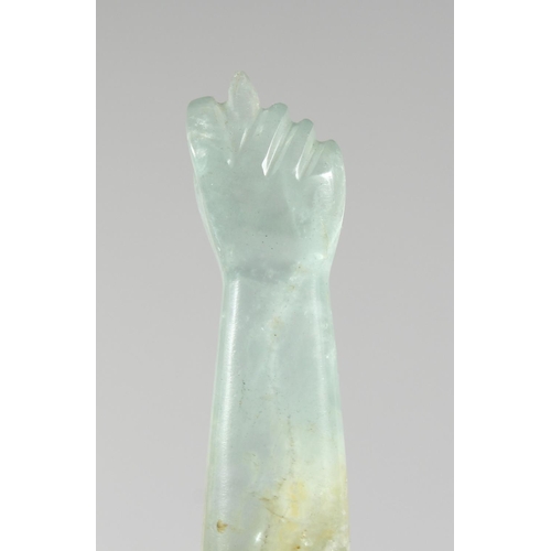 A ROCK CRYSTAL ARM AND HAND with gold mount. 3ins long.