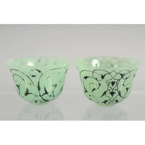 A SMALL PAIR OF ISLAMIC GLASS CUPS, 6cm diameter.
