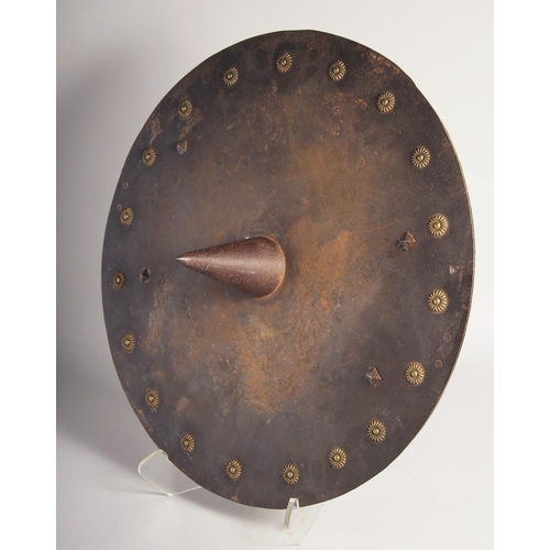 A 19TH CENTURY INDIAN SHIELD with large central spike, likely for a ...