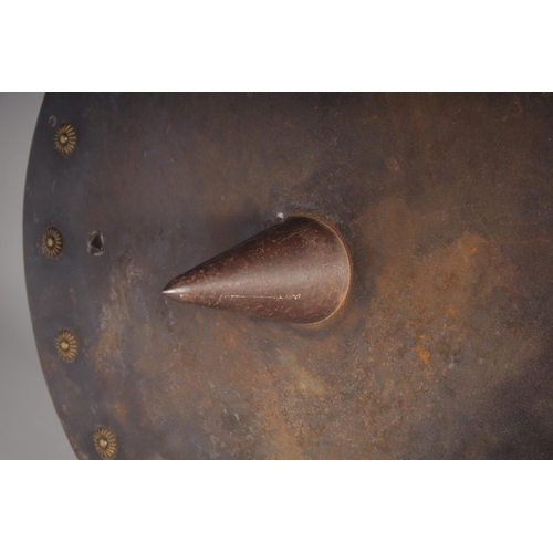 A 19TH CENTURY INDIAN SHIELD with large central spike, likely for a ...