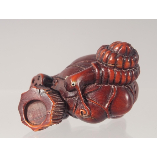 A CARVED WOOD NETSUKE modelled as a dragon 5cm long.