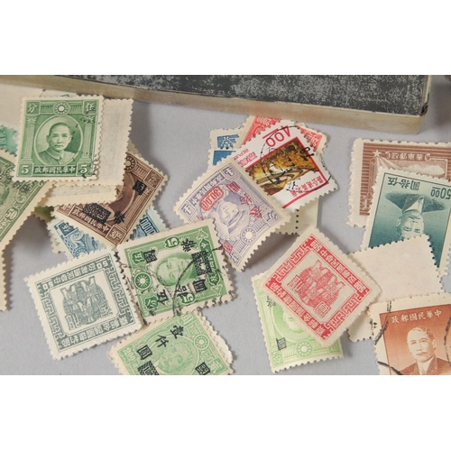 A BOX OF OLD CHINESE STAMPS.