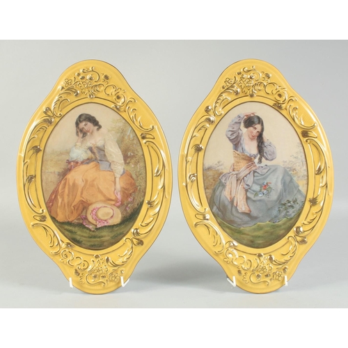 A PAIR OF SEVRES STYLE OVAL YELLOW WALL PLAQUES with portraits of a ...