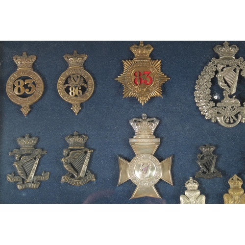 A FRAMED COLLECTION OF 19 SILVER AND BRONZE BADGES, COUNTY LOUTH RIFLES ...