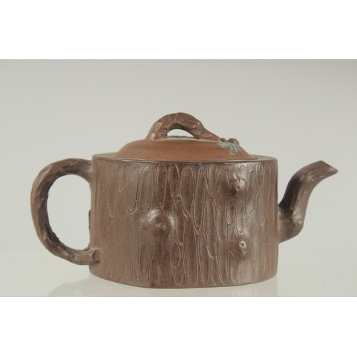 A SMALL CHINESE YIXING TEAPOT, carved with naturalistic forms, the base ...
