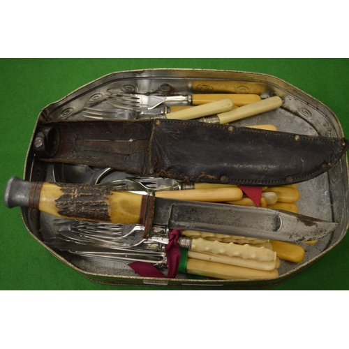 A sheath knife with antler handle and a quantity of flatware.