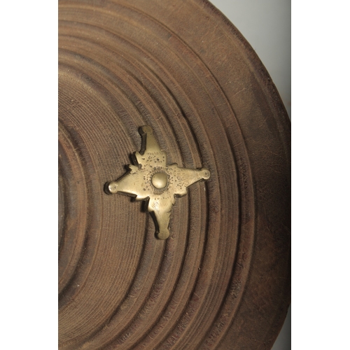 A RARE 19TH CENTURY ARAB OMANI LEATHER SHIELD, with two mounted brass ...