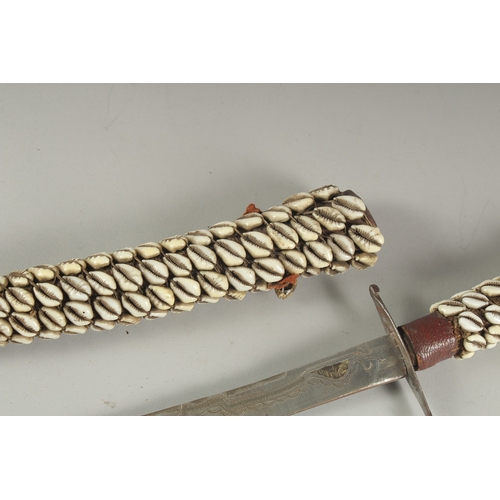 A COWIE SHELL COVERED DAGGER AND SHEATH. 19ins long.