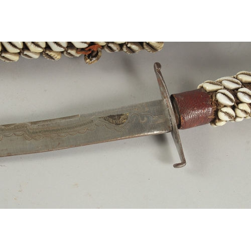 A COWIE SHELL COVERED DAGGER AND SHEATH. 19ins long.