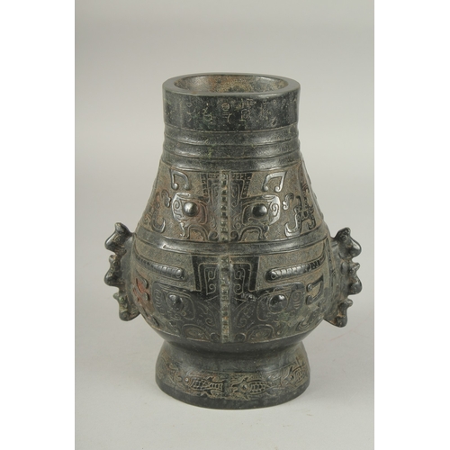 A CHINESE CARVED HARDSTONE TWIN HANDLE VASE, with archaic style designs ...