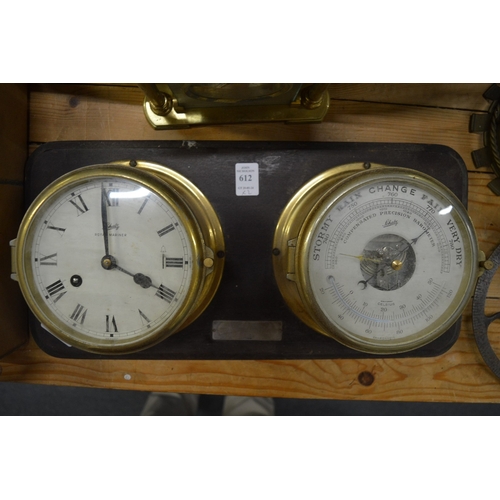 A brass ships clock and matching barometer/thermometer mounted on a ...