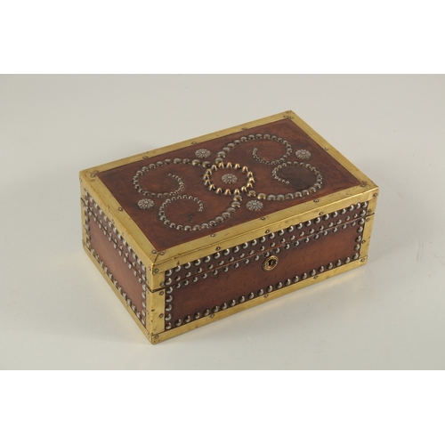 A BRASS BANDED AND STUDDED LEATHER BOX. 10ins long x 4ins high x 6ins deep.