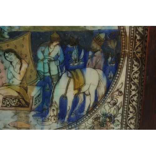 A 19TH CENTURY PERSIAN QAJAR GLAZED POTTERY TILE, the centre with ...