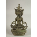 A FIGURE OF A SEATED MULTI-HEADED DEITY, 22cm high.