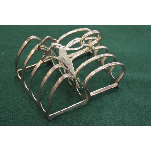 Two small silver toast racks.