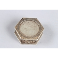 A CHINESE WHITE METAL OCTAGONAL COIN BOX set with two Chinese coins. 1 ...