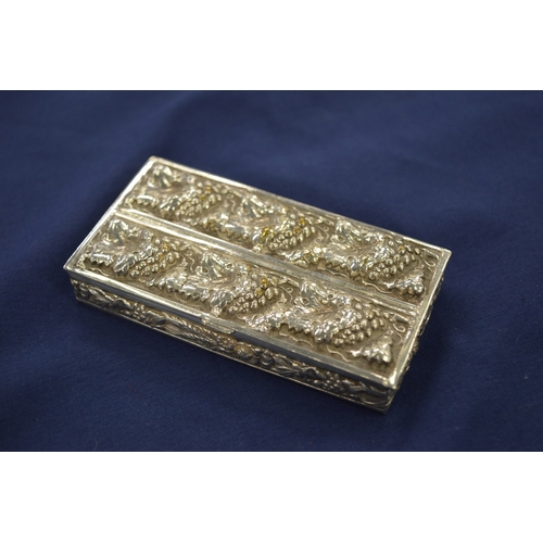 An embossed white metal box.