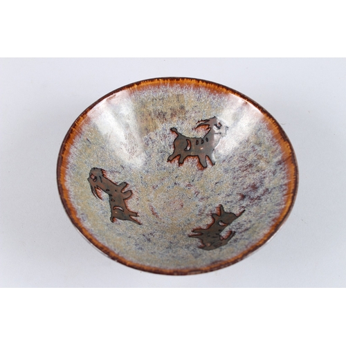 A CHINESE POTTERY BOWL decorated with goats. 6ins diameter.