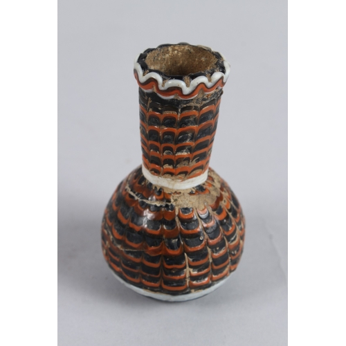 A FINE, POSSIBLY EARLY ISLAMIC OR ROMAN, MOSAIC GLASS VASE. 4ins high.
