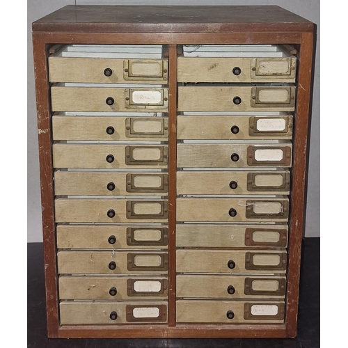 Vintage wooden cabinet fitted with 20 drawers all with turned handles.