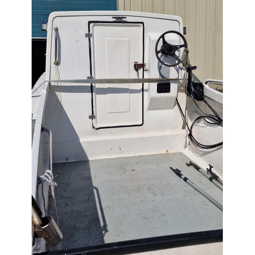 A dory boat and trailer with outboard motor, spare life jackets ...