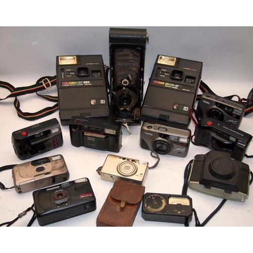 A collection of vintage film cameras including polaroid instant cameras ...