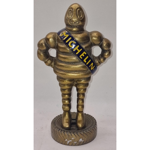 Cast metal painted Michelin man figure 28cm tall.