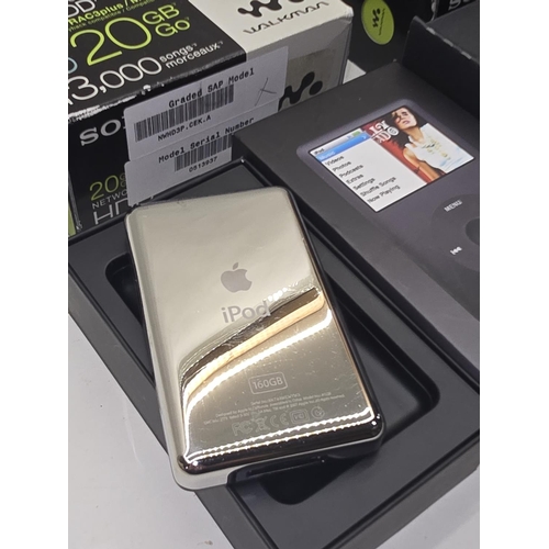 Two Sony NW-HD3 Network Walkman portable stereos together with an Apple ...