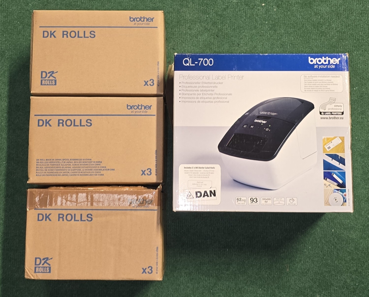 A Brother QL-700 Professional label printer together with three boxes ...