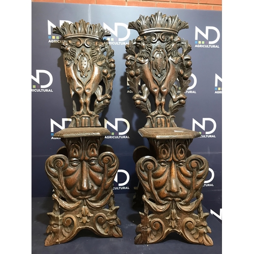 PAIR OF HEAVILY CARVED BLACK FOREST CHAIRS