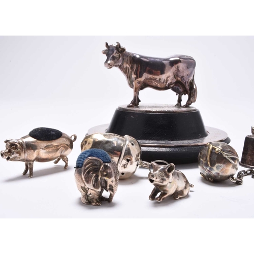 A modern novelty silver pin cushion in the form of a pig, together with ...
