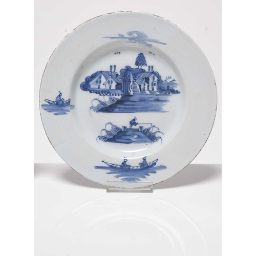 A Liverpool delft plate, circa 1760, painted in blue with two houses in ...