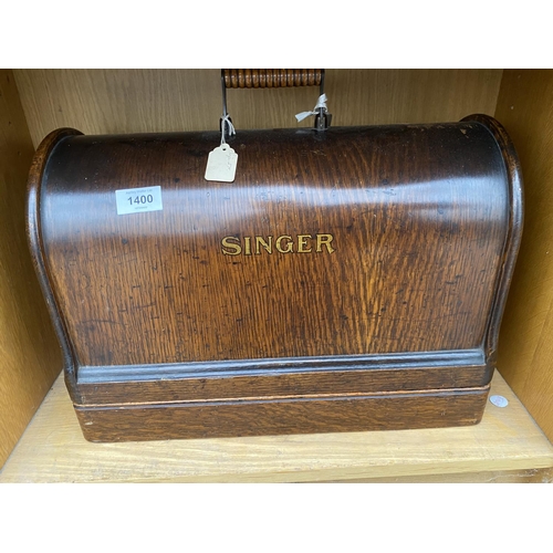 A VINTAGE SINGER SEWING MACHINE WITH WOODEN CARRY CASE