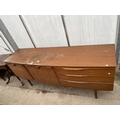 A RETRO TEAK 'BEAUTILITY' SIDEBOARD WITH THREE DRAWERS AND TWO ...