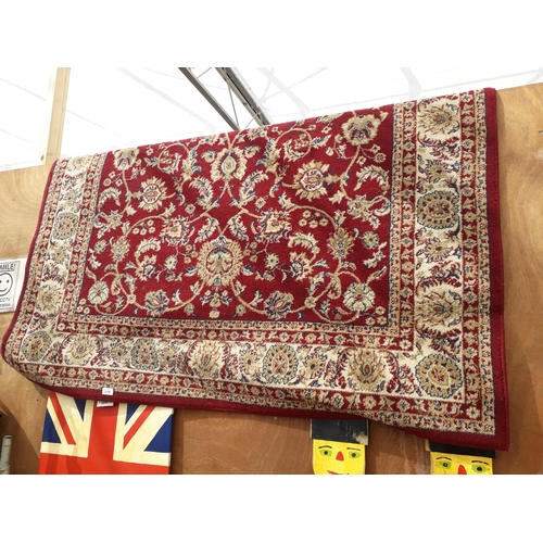 A MODERN RED PATTERNED RUG