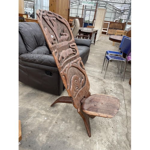 AN AFRICAN FOLDING TRIBAL CHAIR WITH WILD ANIMAL CARVINGS TO BACK