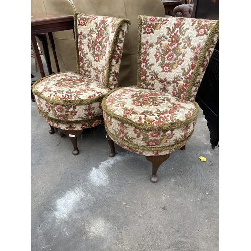 A PAIR OF FLORAL UPHOLSTERED BEDROOM CHAIRS ON FRONT CABRIOLE LEGS