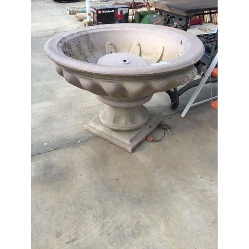 A LARGE PLASTIC WATER FEATURE