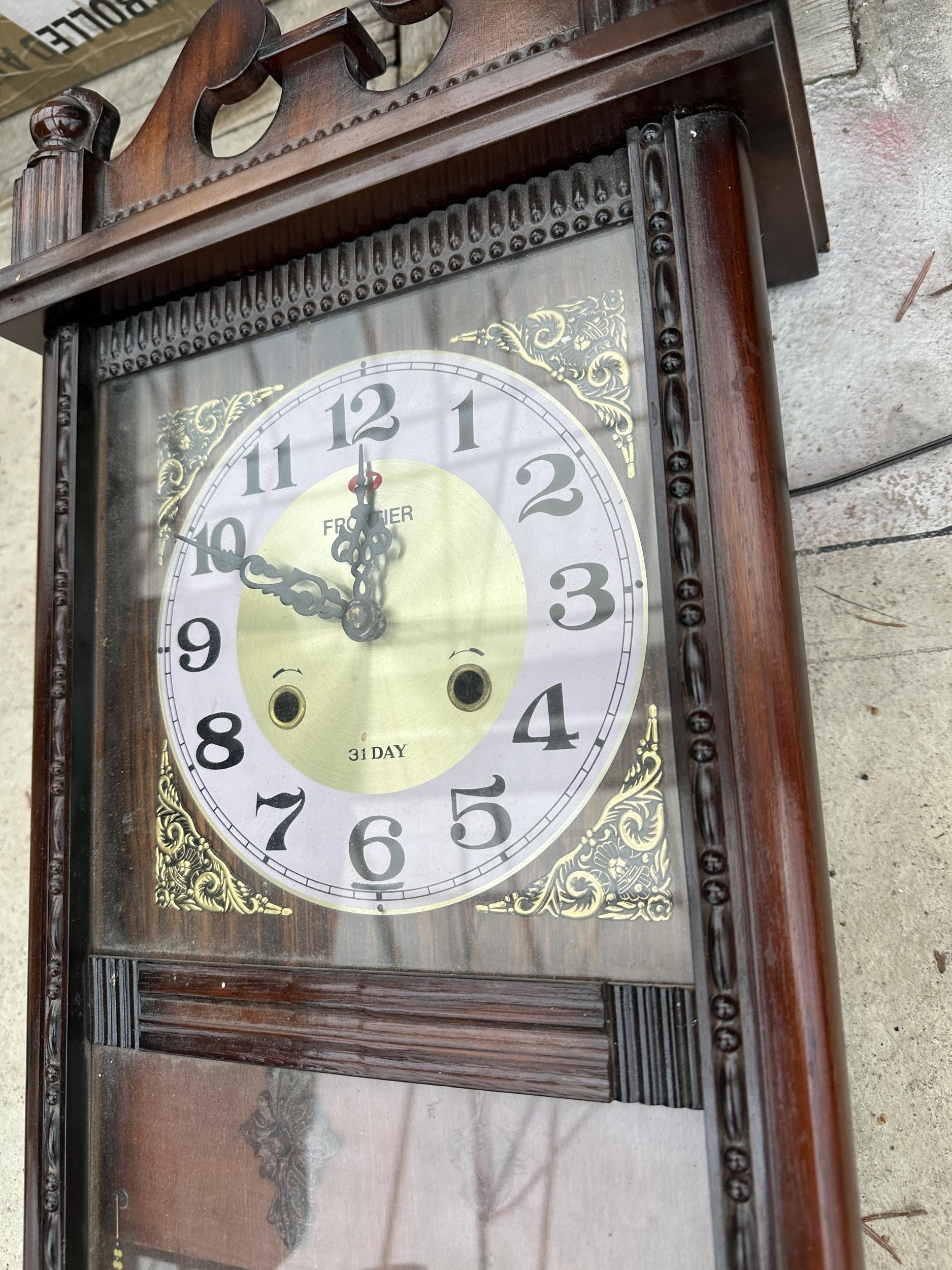 A CHIMING 31 DAY WALL CLOCK